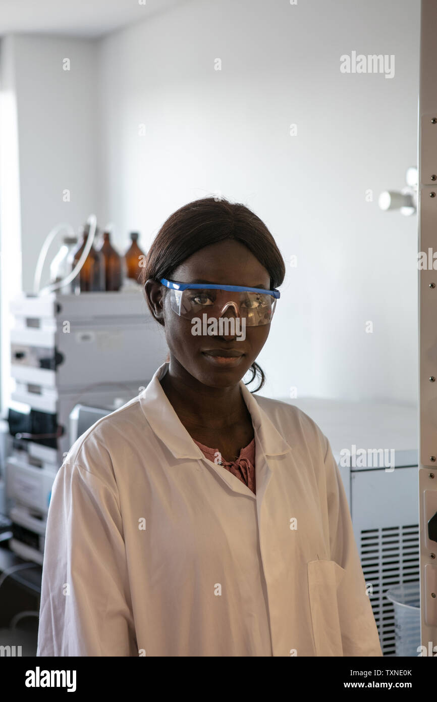 Young female scientist wearing safety glasses in laboratory, portrait ...