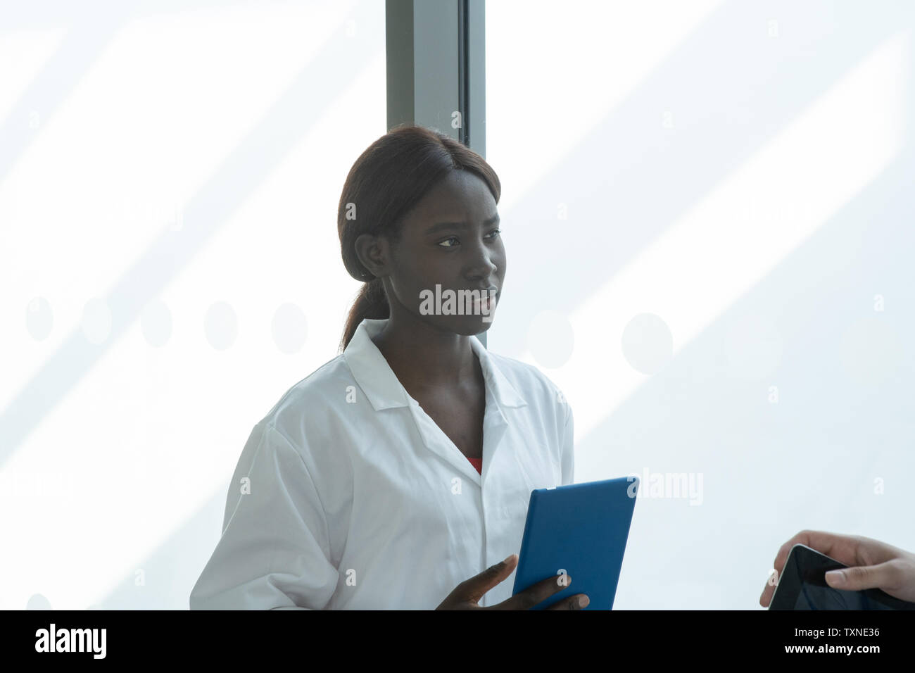Young female and male scientists with digital tablet and smartphone ...
