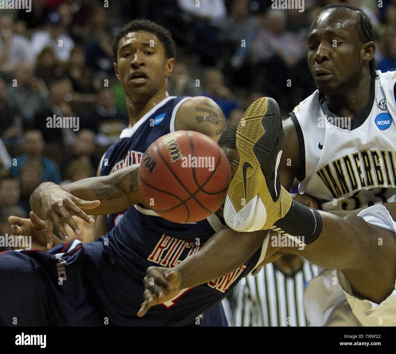 Vanderbilt forward Steve Tchiengang kicks the ball away from Richmond forward Darrius Garrett ...