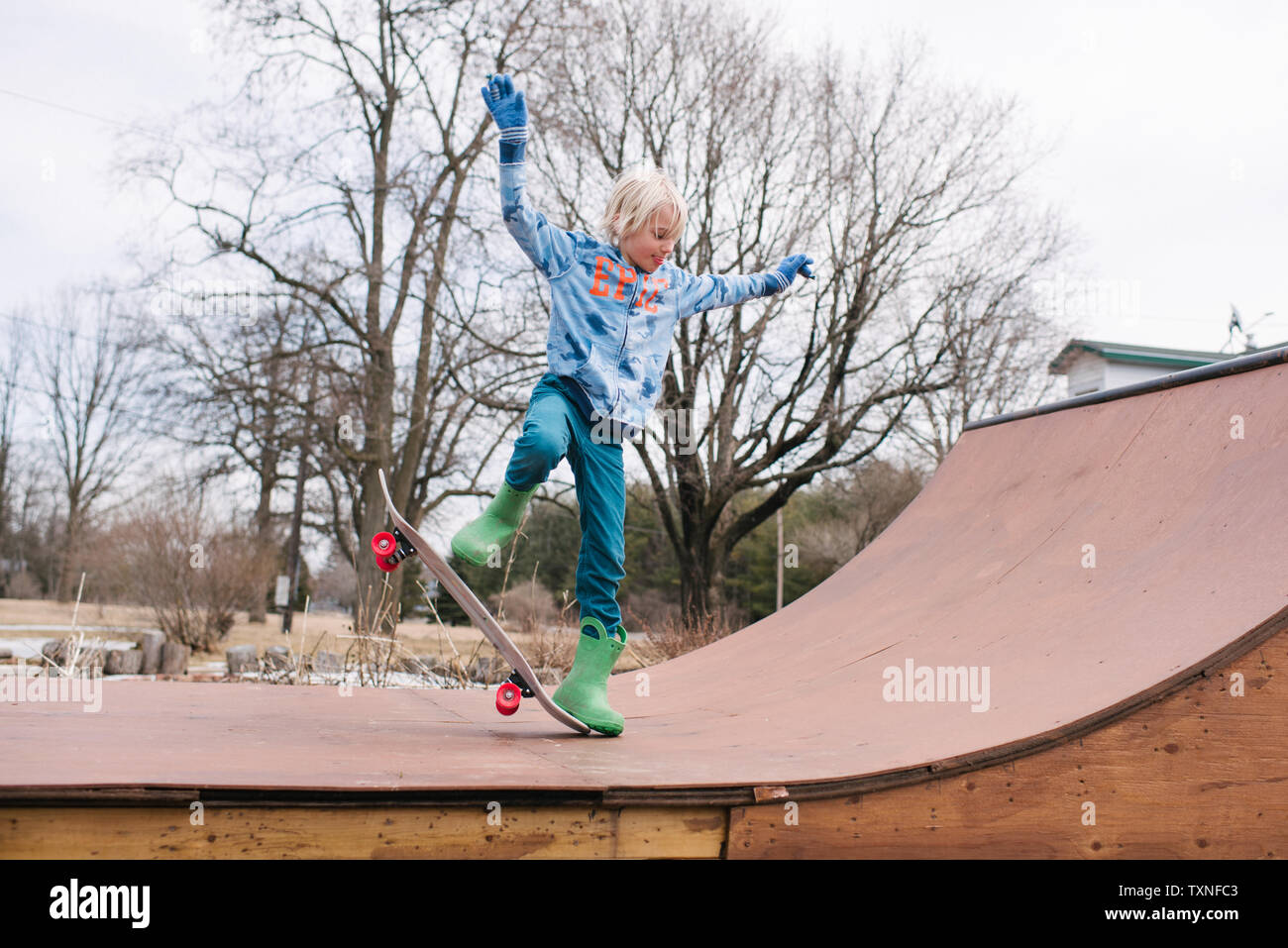 Boy on rural skateboard ramp practicing skateboarding trick Stock Photo ...
