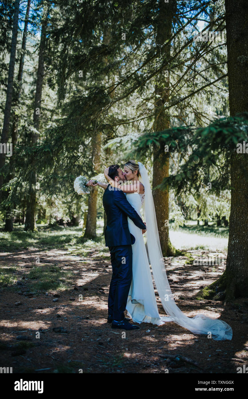 Romantic groom lifting up bride to kiss in woodland Stock Photo - Alamy