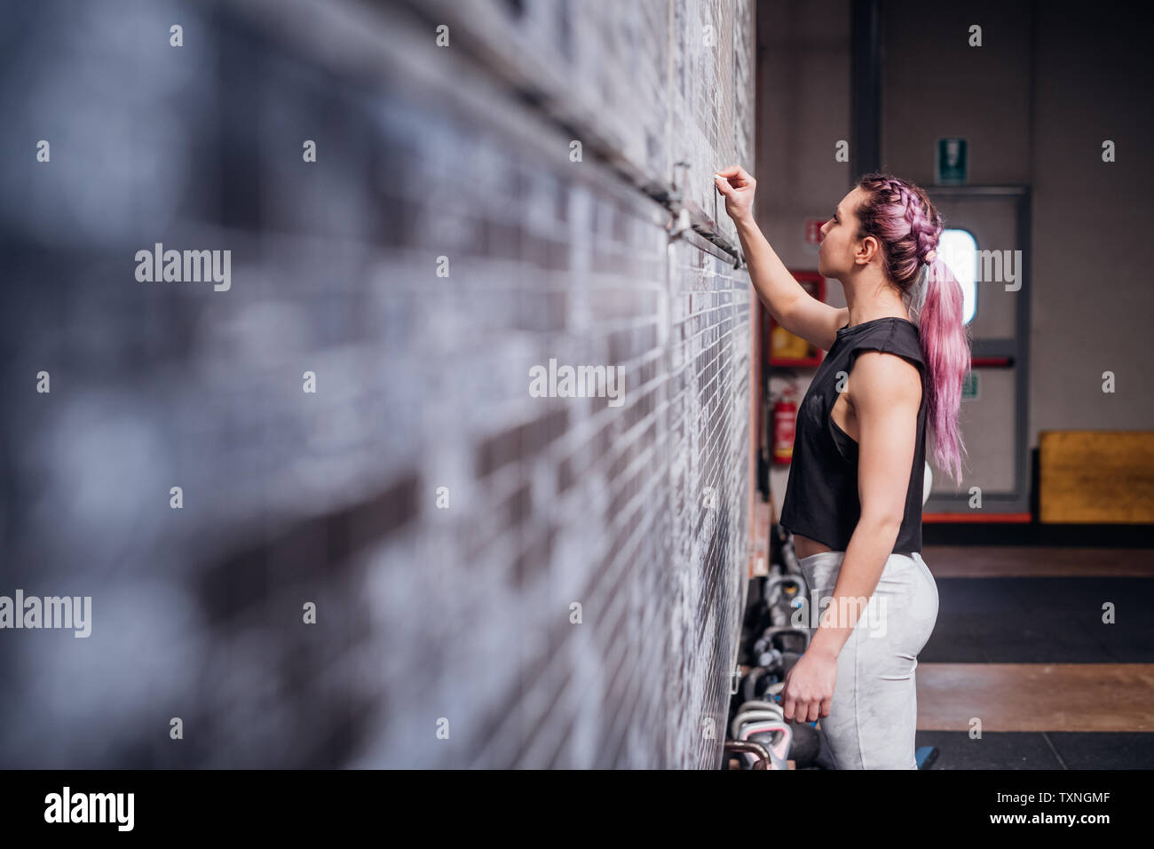 Young woman writing on scoreboard in gym Stock Photo - Alamy
