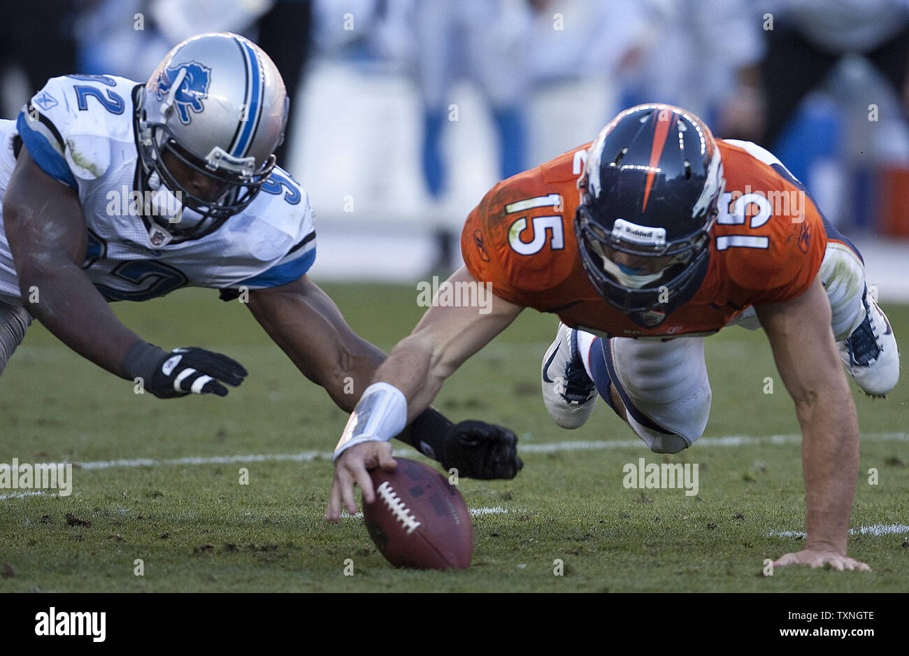 Denver Broncos quarterback Tim Tebow (15) recovers his own fumble on a ...