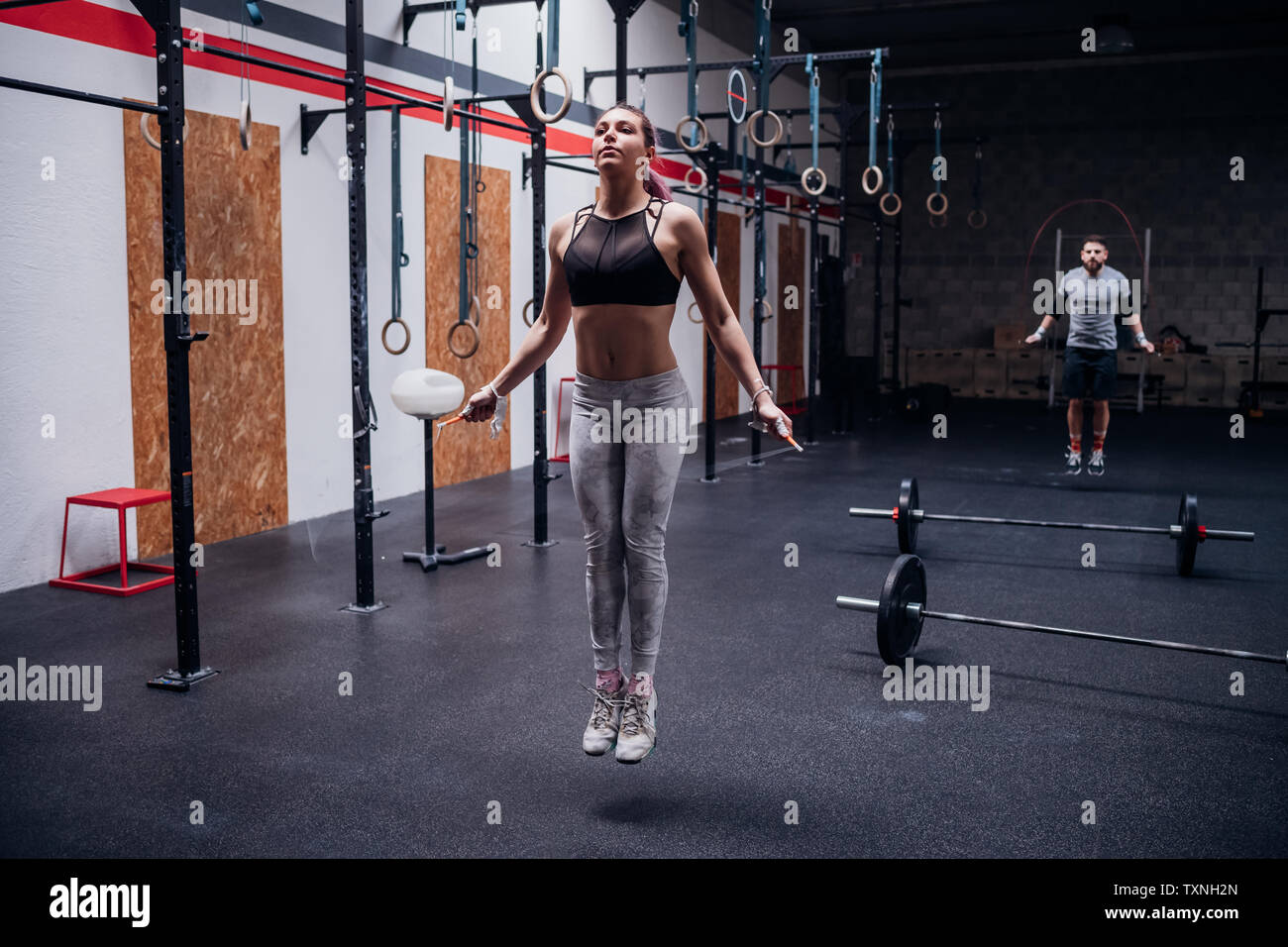 Young woman skipping in gym Stock Photo - Alamy