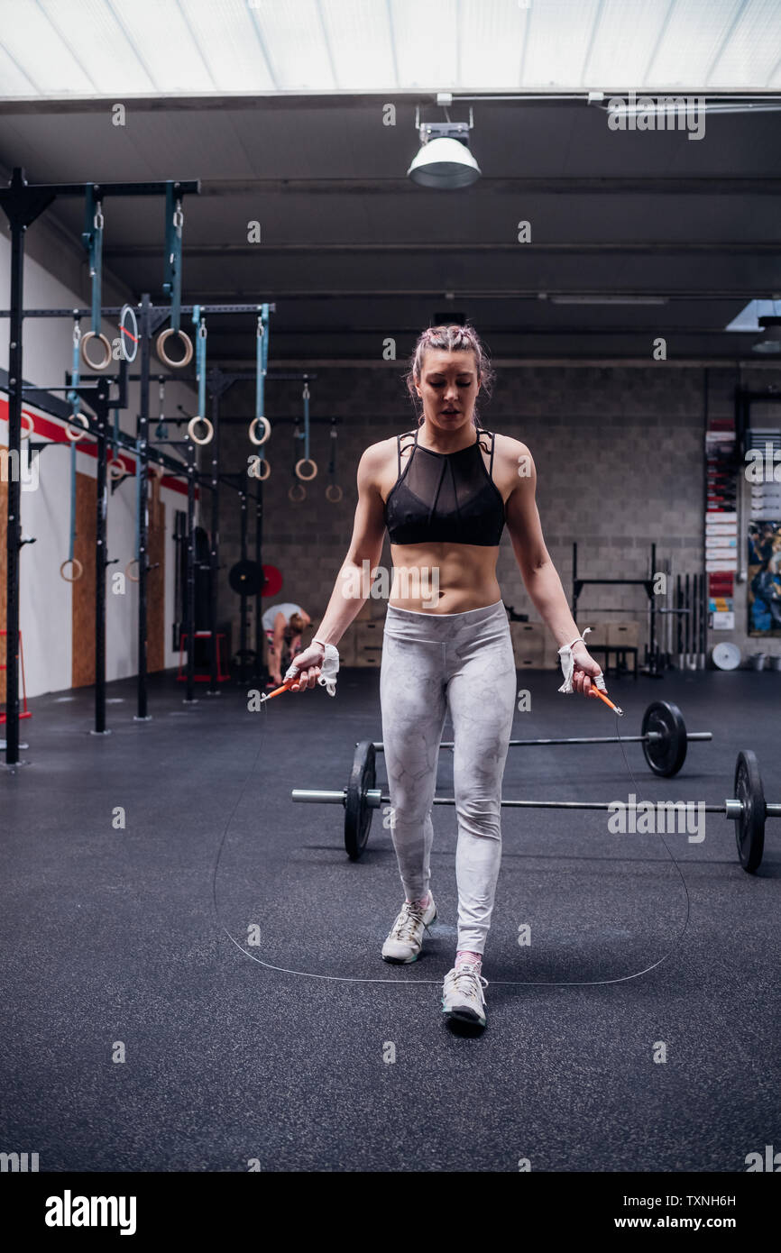 Young woman skipping in gym Stock Photo - Alamy