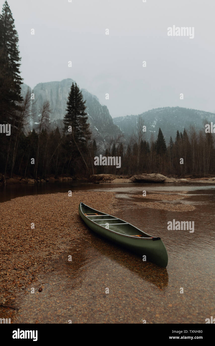 Canoe beached on river shallows, Yosemite Village, California, USA ...