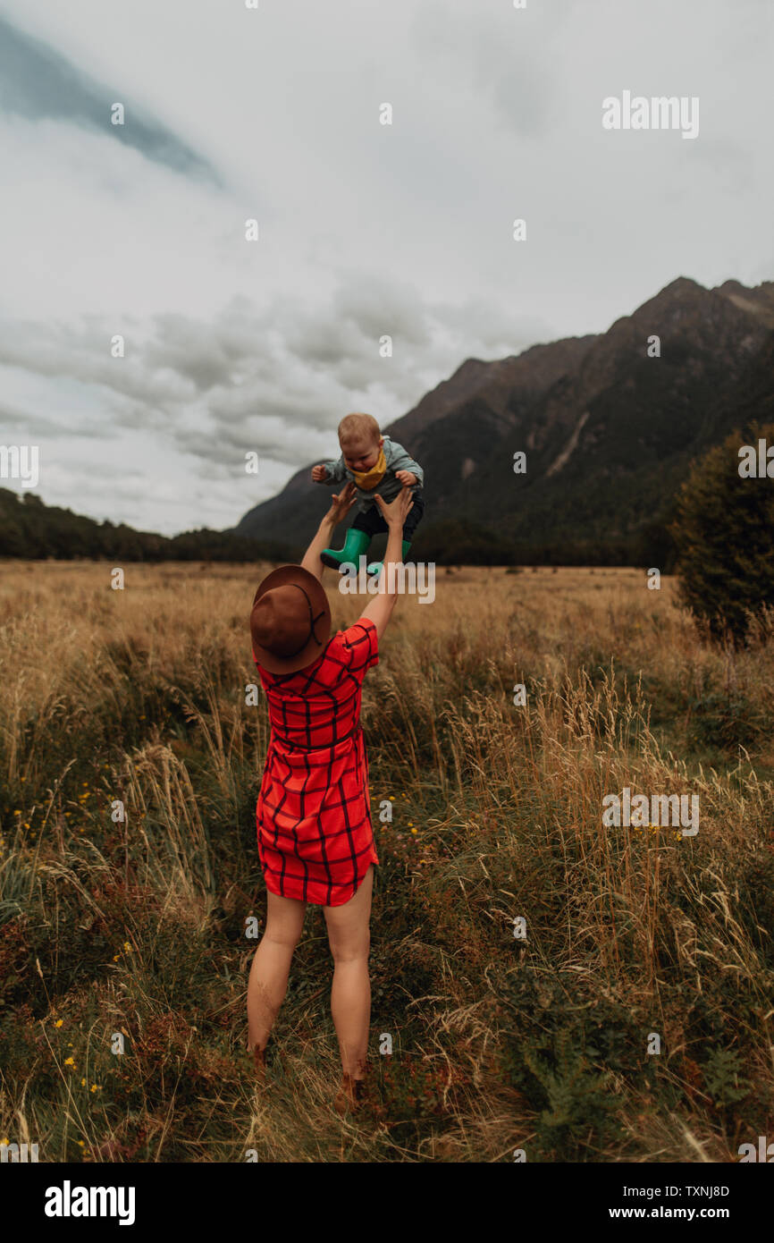 Mother playing with baby in wilderness, Queenstown, Canterbury, New ...