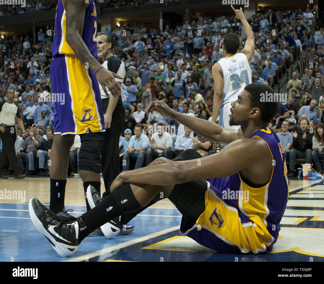 Los Angeles Lakers center Andrew Bynum looks for help getting up while ...