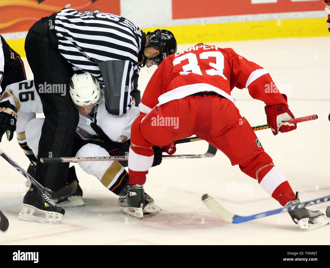 NHL linesman Mike Cvik falls as Anaheim Mighty Ducks center Samuel ...