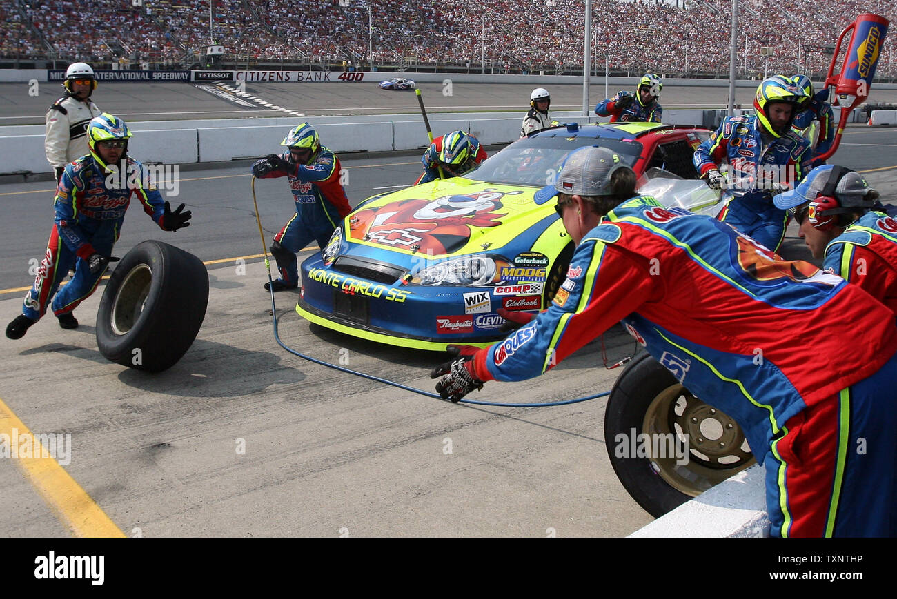 Nascar driver Kyle Busch gets a set of new tires and gas from his pit ...