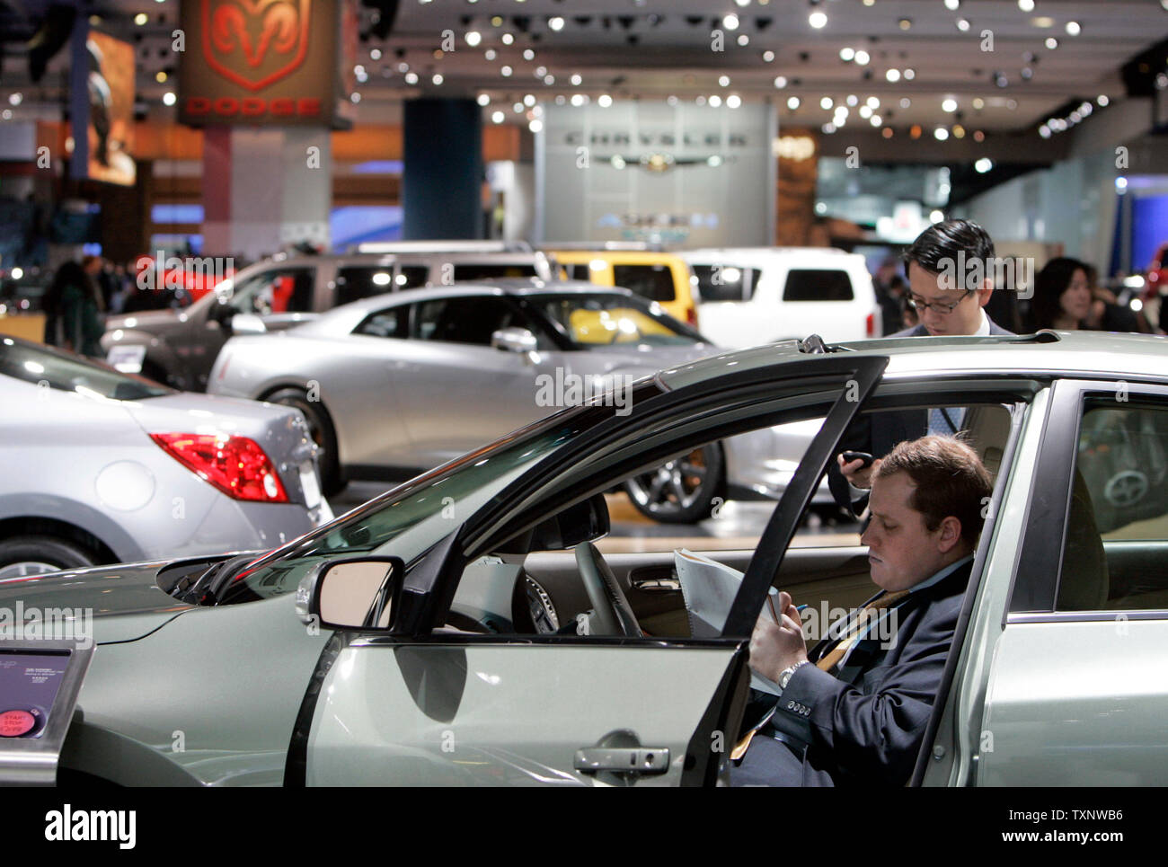 Members of the media look over the new Nissan Motors Co. cars during ...