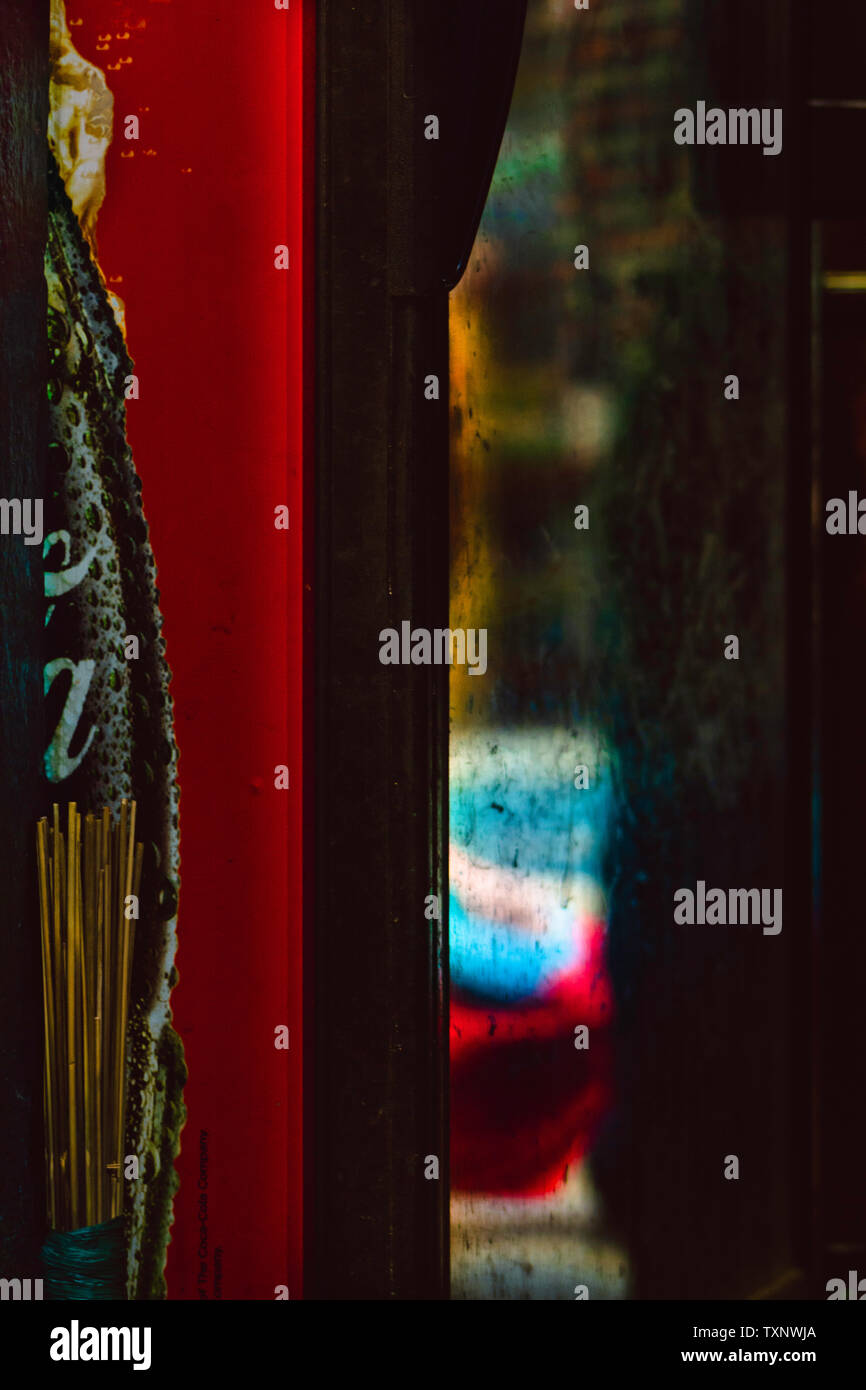 A red refrigerator in its side view with coloured exterior being ...