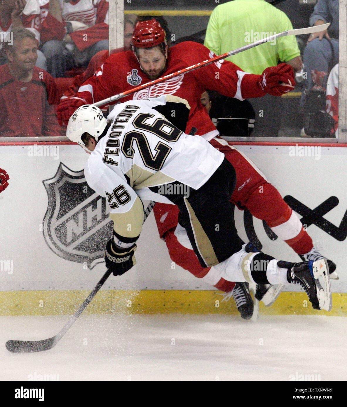 Pittsburgh Penguins left wing Ruslan Fedotenko (26) checks Detroit Red ...