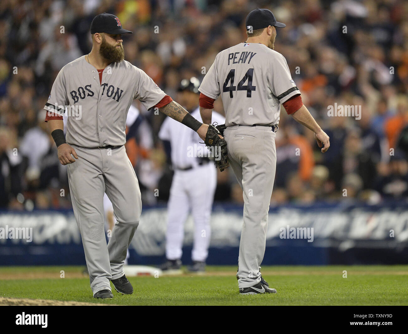 Boston Red Sox first baseman Mike Napoli (L) gives a pat on the back as ...