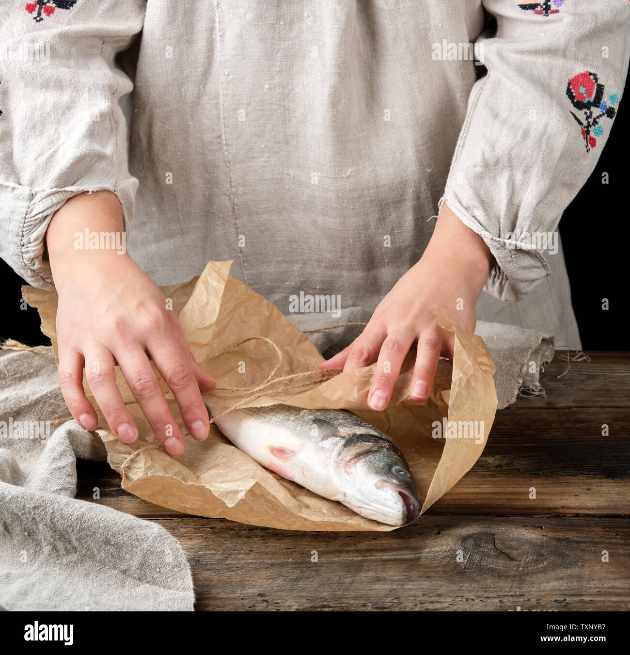 Whole fish wrapped in paper hi-res stock photography and images - Alamy