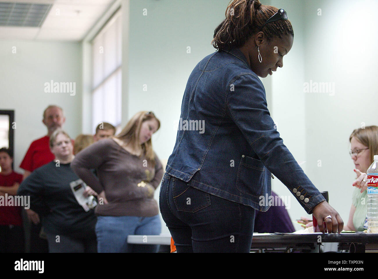 A Democrat voter signs in before receiving her ballot from a precinct ...
