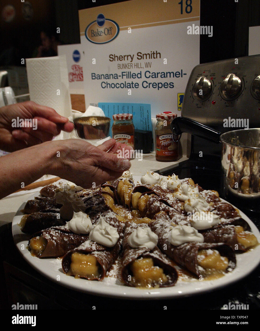 Finalist Sherry Smith of Bunker Hill, West Virginia sprinkles a handful ...