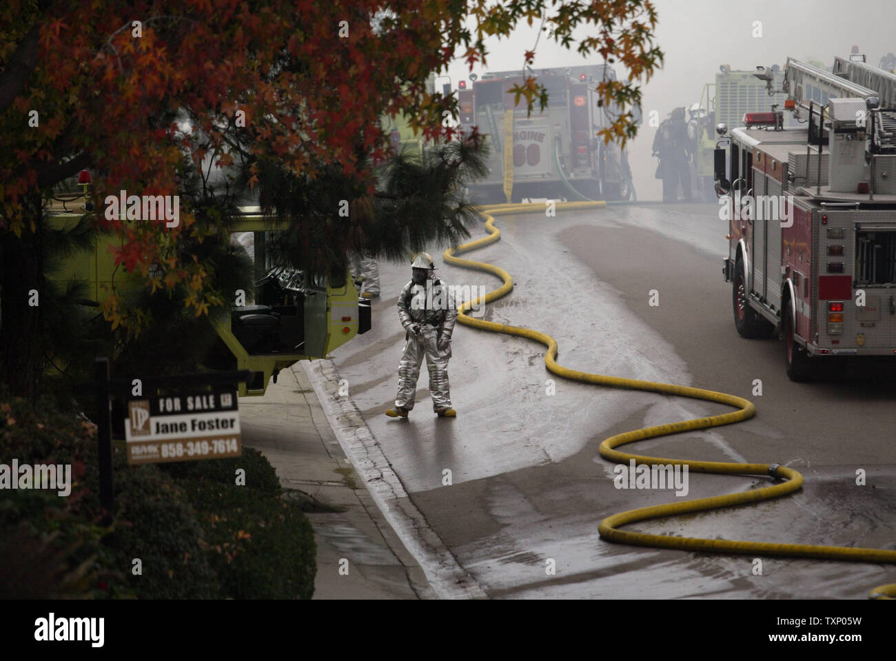 A Marine Corps firefighter works on Lipmann Street at the scene of an ...