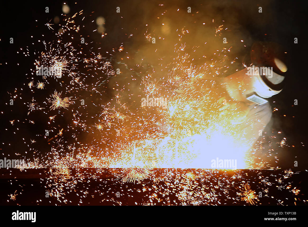 Chinese welders work at DHI-DCW's heavy industry manufacturing factory ...