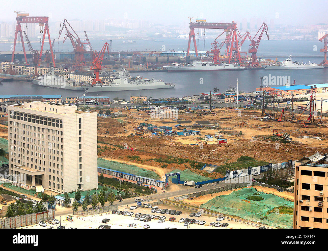 Five Chinese naval ships going through various stages of construction ...