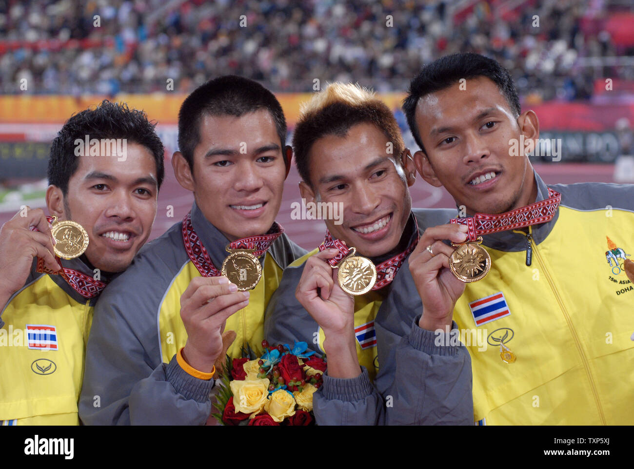 Thailand's 4x100 relay team hold up their gold medals at the 15th Asian ...