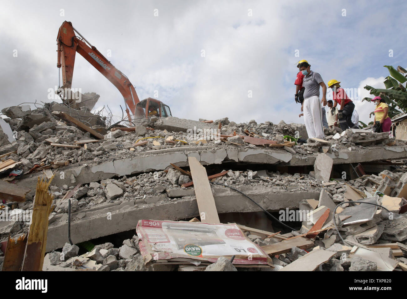 Peruvian rescuers look for survivors of an earthquake in the Tarqui ...