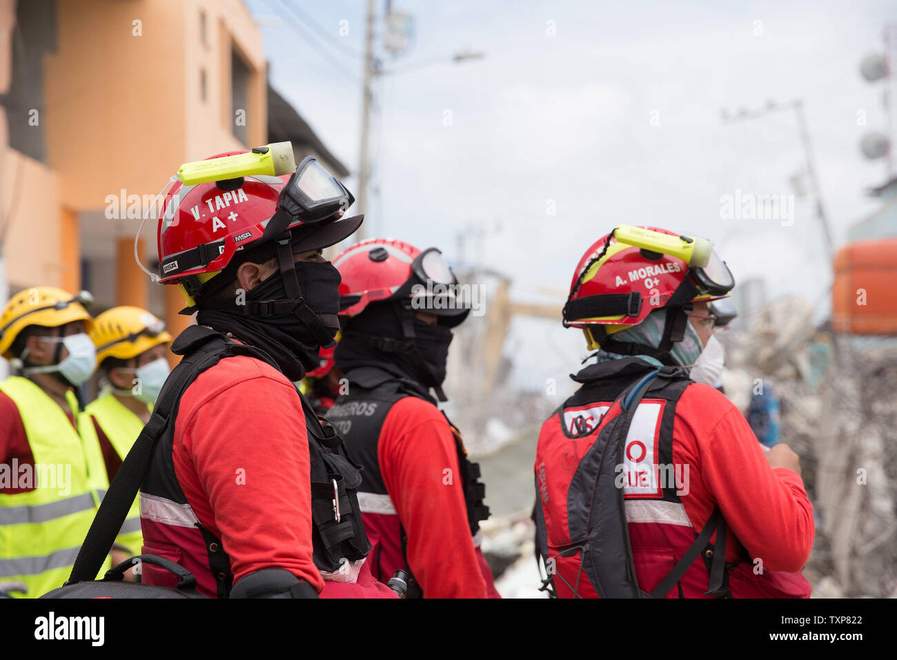 Peruvian rescuers look for survivors of an earthquake in the Tarqui ...