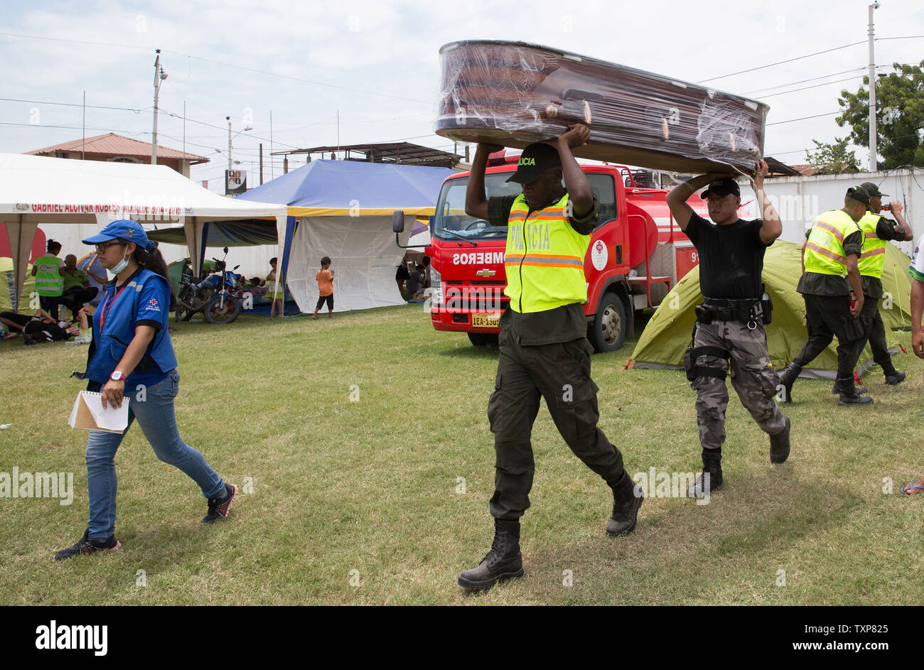 Soldiers load coffins after an earthquake struck off the Pacific coast ...