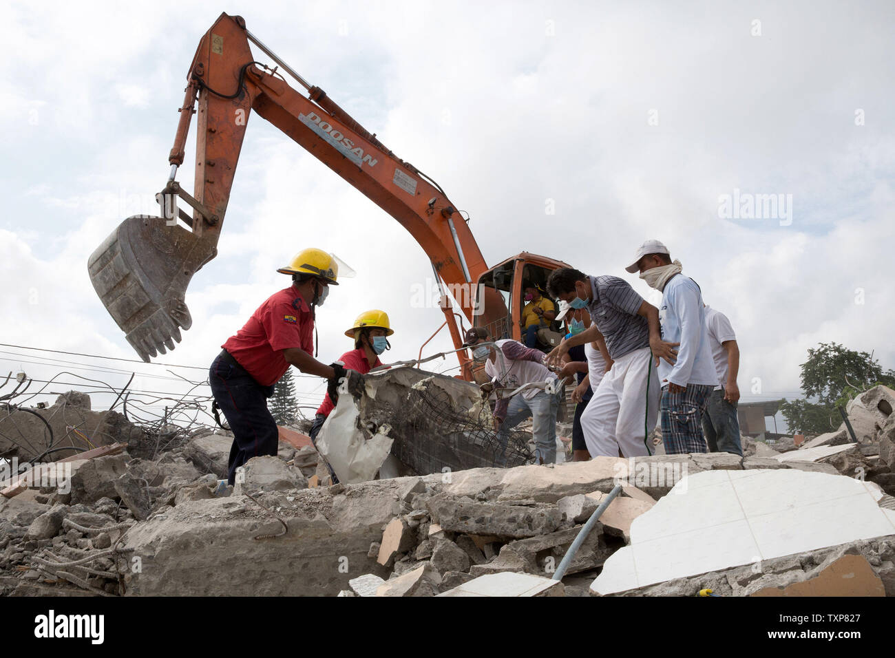 Peruvian rescuers look for survivors of an earthquake in the Tarqui ...