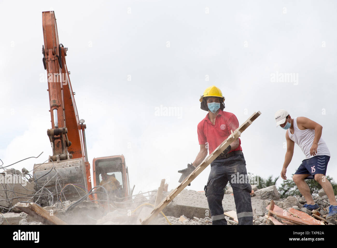 Peruvian rescuers look for survivors of an earthquake in the Tarqui ...