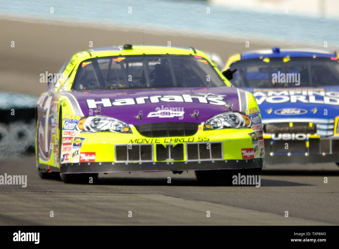 Robby Gordon, in car Number 7, passes John Andretti, in car Number 10 ...