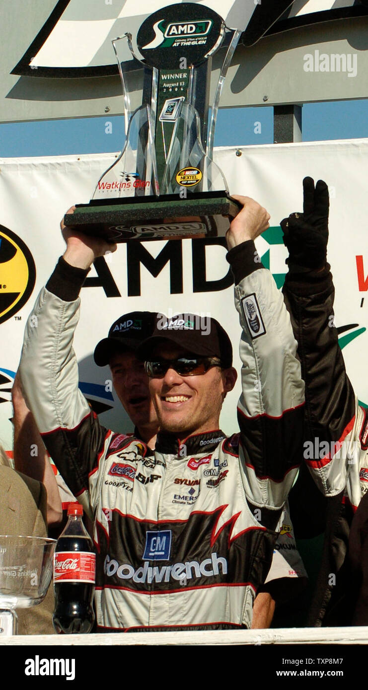 Kevin Harvick, driver of car number 29, holds up the AMD Cup and ...