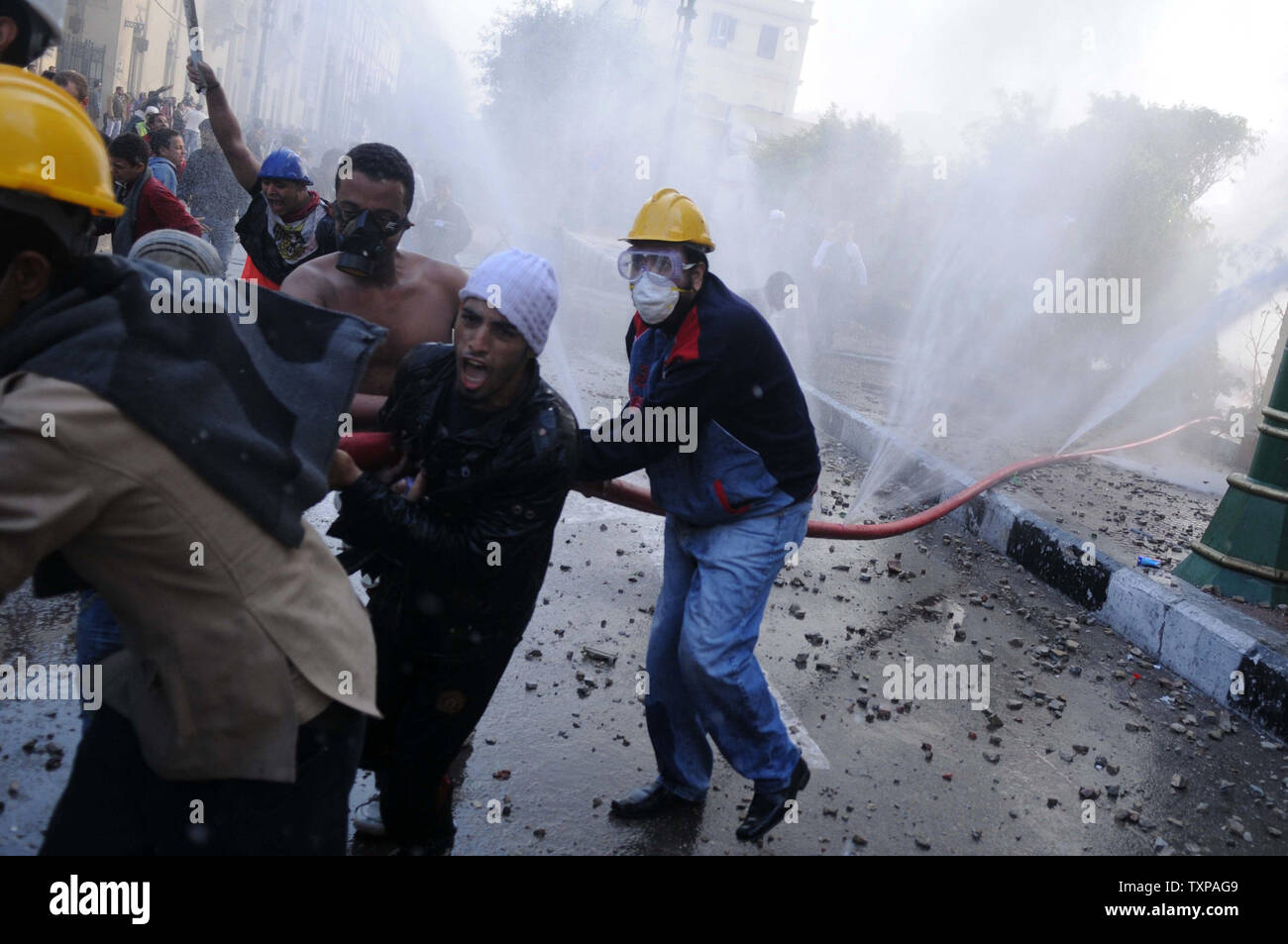Egyptian firefighters spray water during clashes with security forces ...