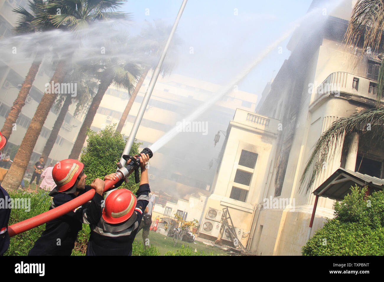 Firefighters try to extinguish a fire in a government building that was ...