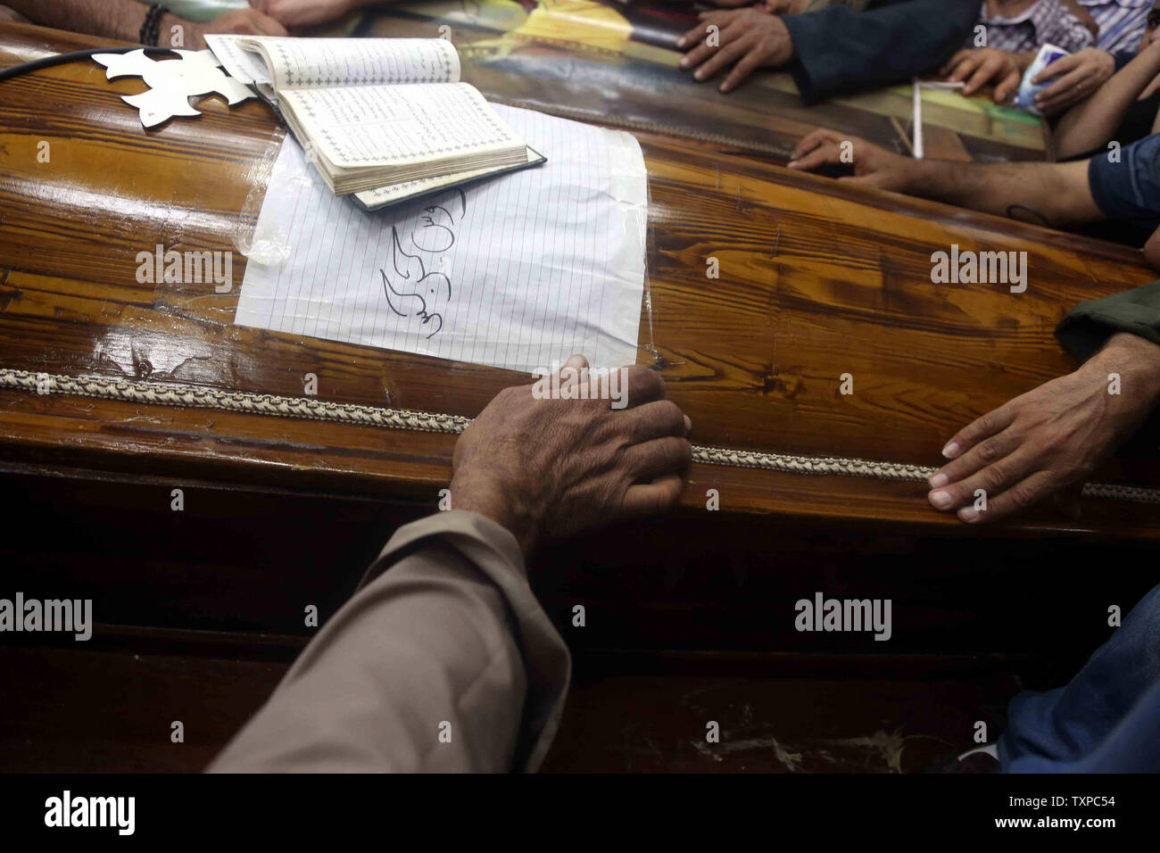 People and Relatives carry the coffins of killed Coptic Christians ...