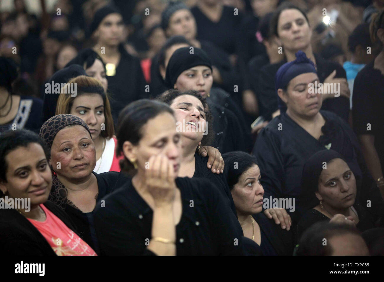Relatives of killed Coptic Christians grieve during their funeral at ...