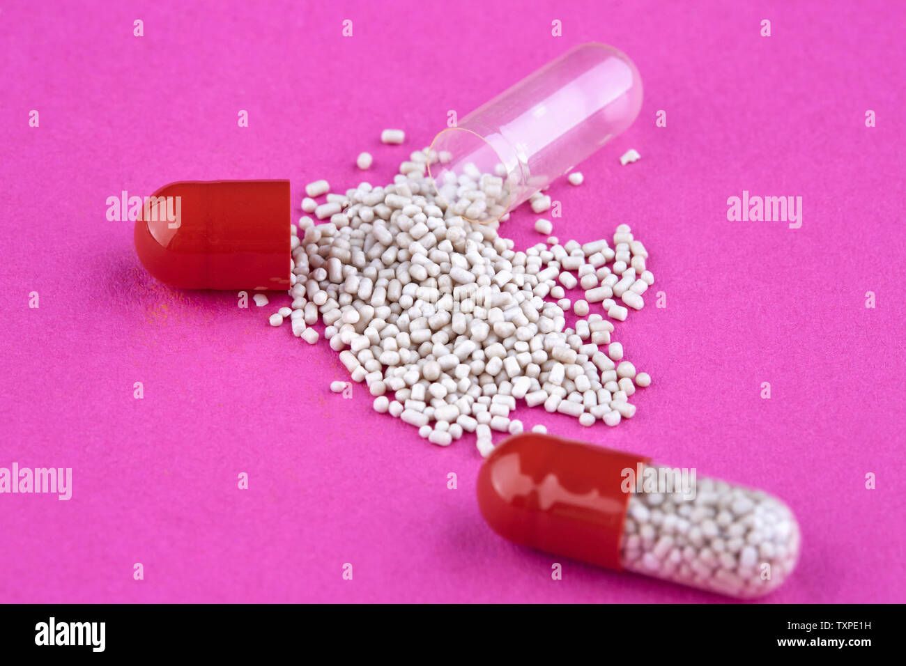 Close-up photo of open capsule with medicine on pink background Stock ...