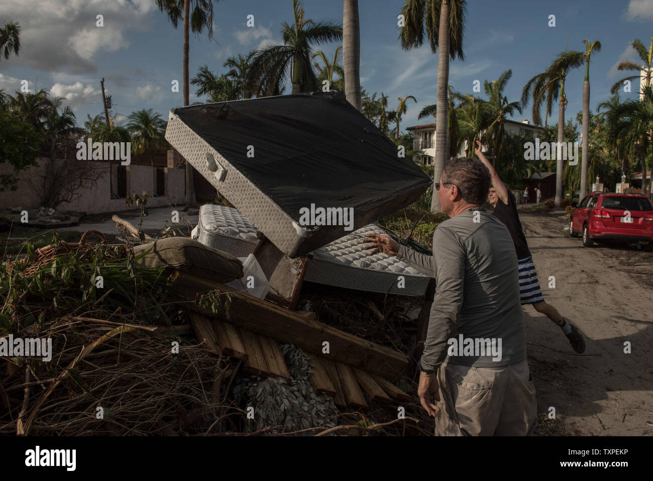 Paul Naron, left, and Mark Grafton, right, clean up damaged items from ...