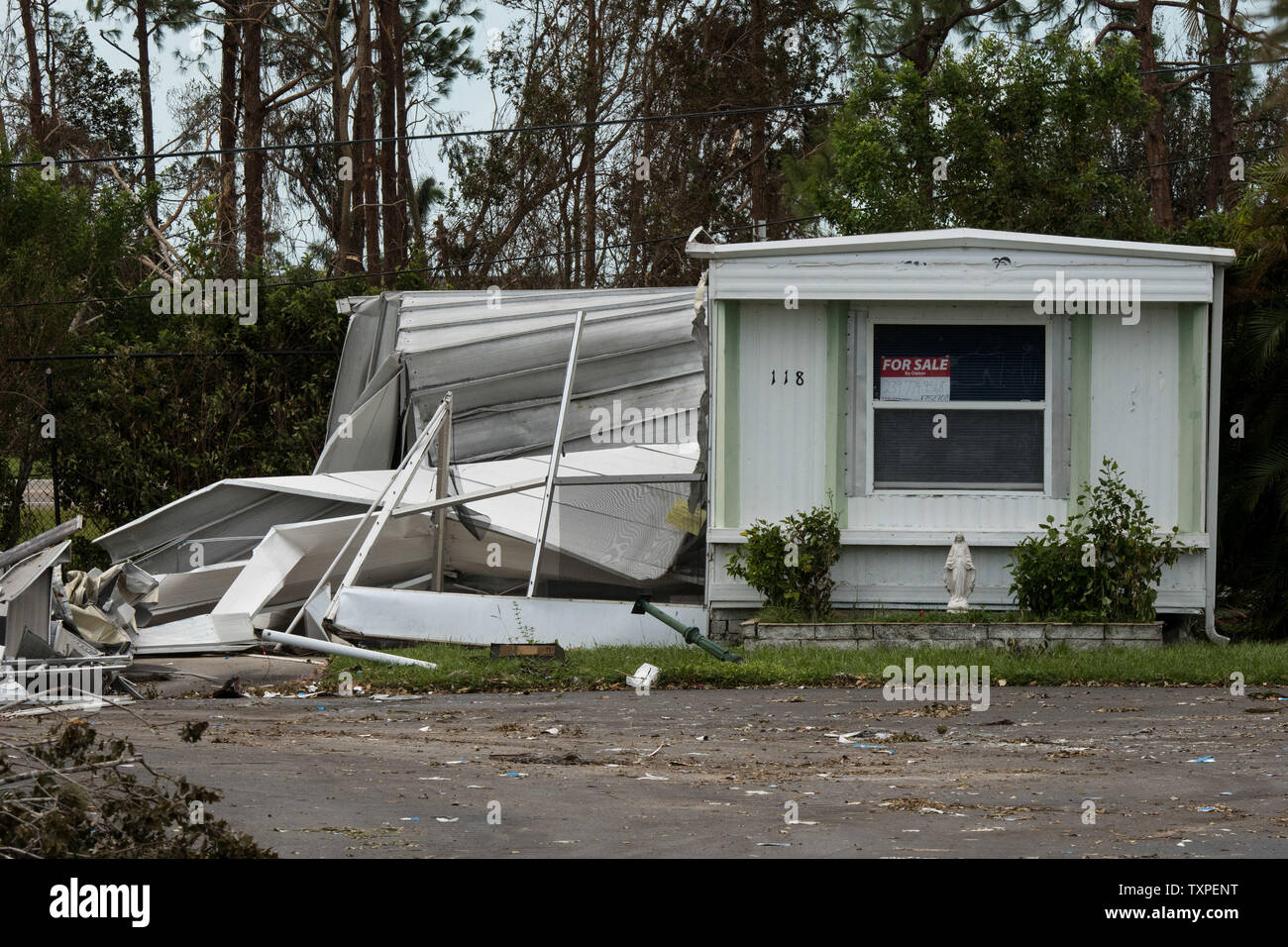 Debris from destroyed mobile homes lay in the yards after Hurricane ...