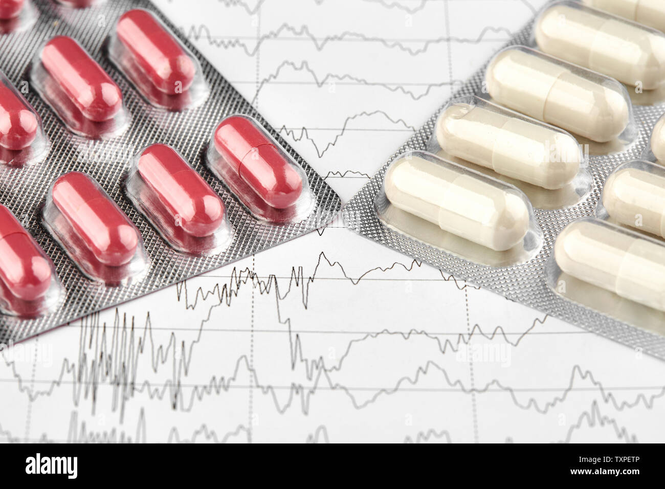 Close-up photo of blister with red and white pills on EKG graph Stock ...
