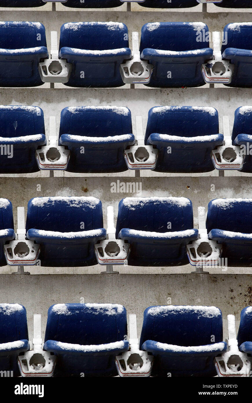 Snow begins to accumulate on the seats in the 200 level section of ...