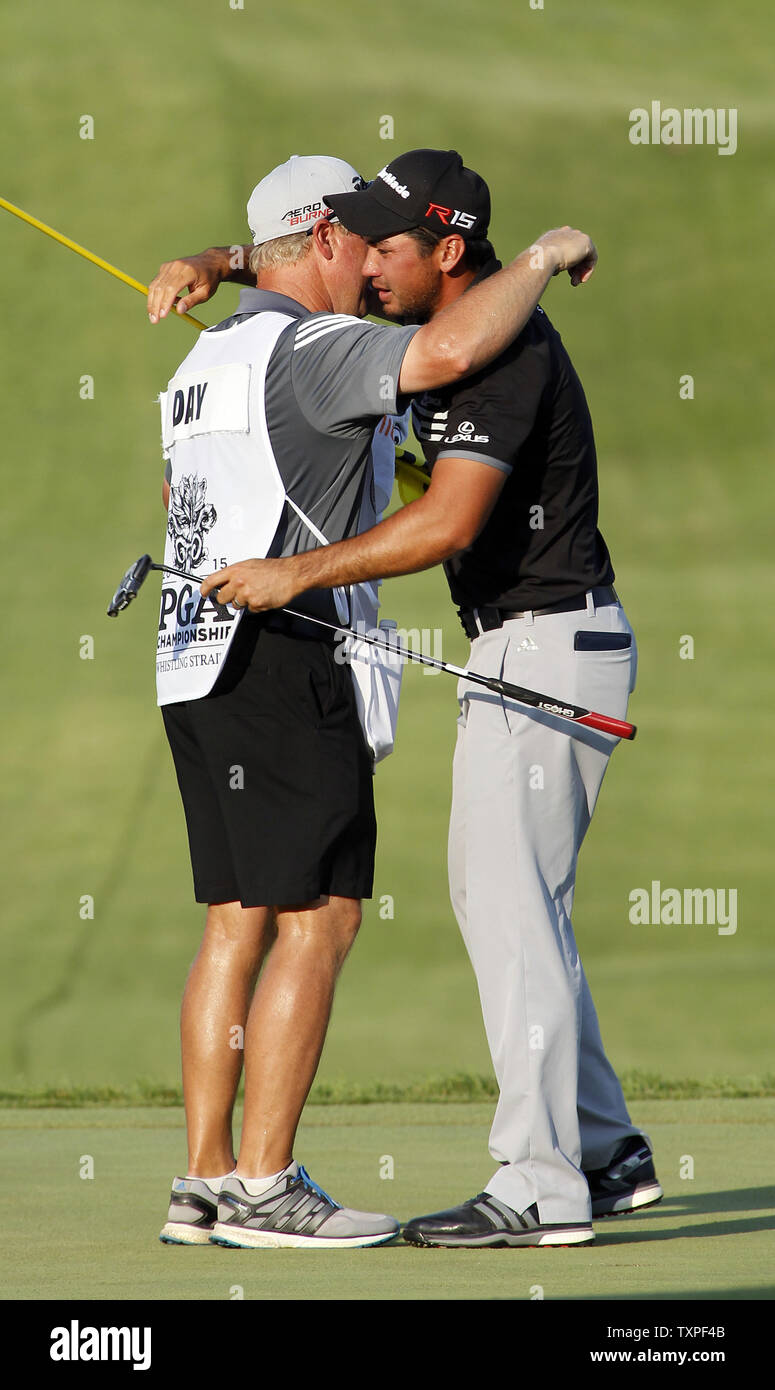 Jason Day right, of Australia, hugs long-time caddie Colin Swatton, after shooting a 20-under ...