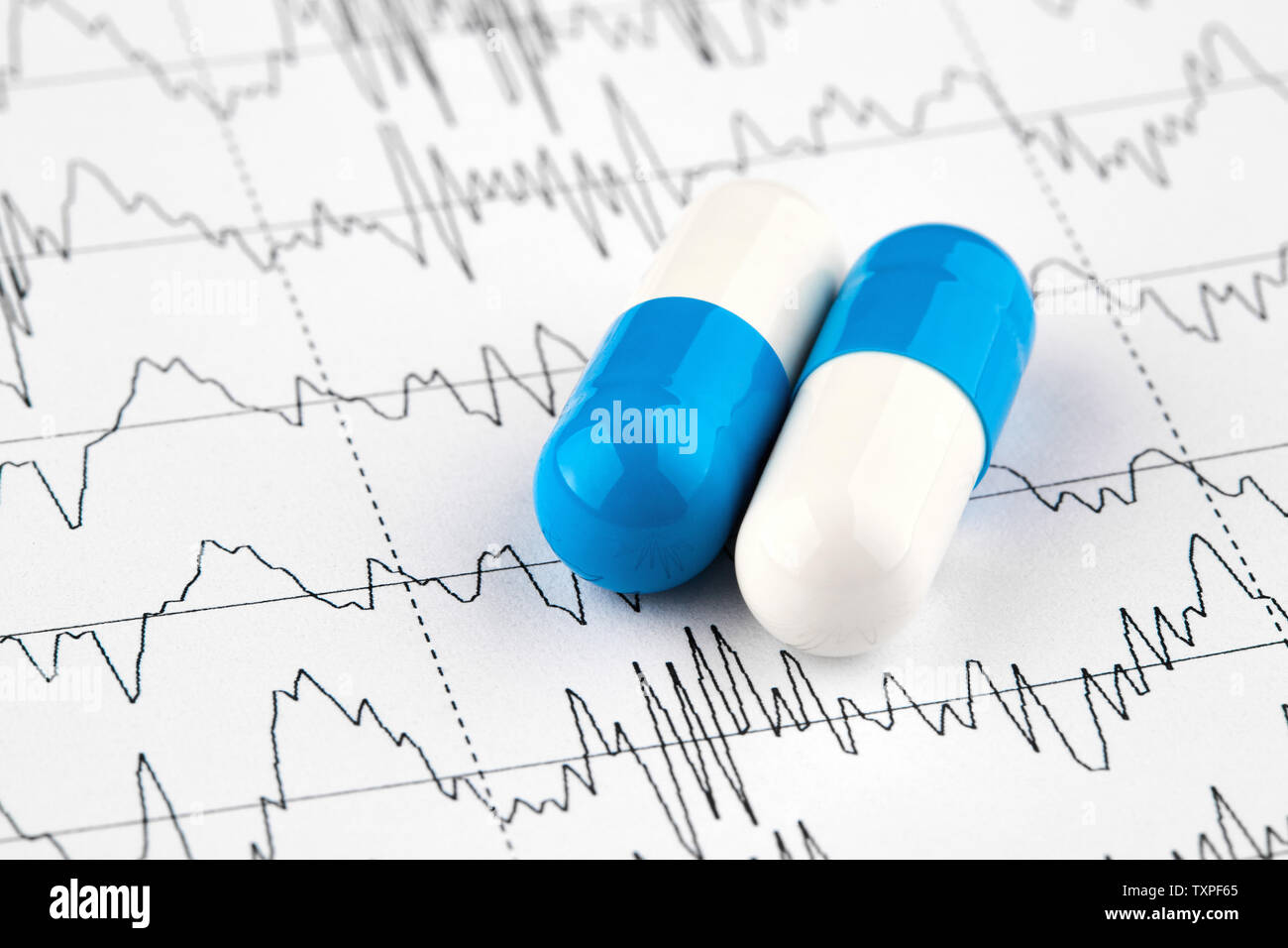 Close-up photo of white and blue pills on EKG graph Stock Photo - Alamy