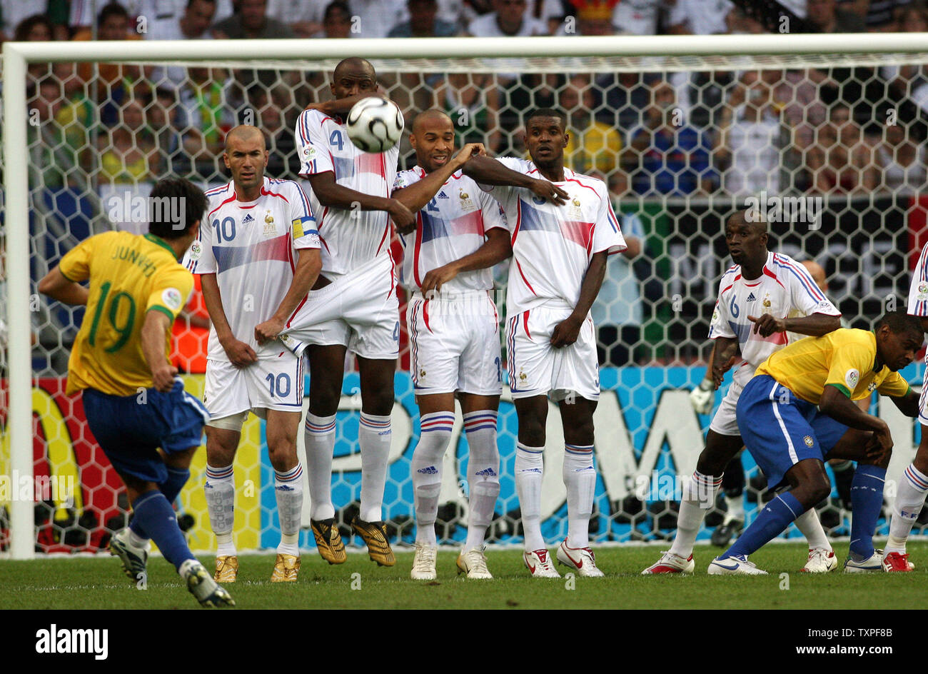 Brazil's Juninho Pernambucano's (19) free kick is blocked by a wall of ...