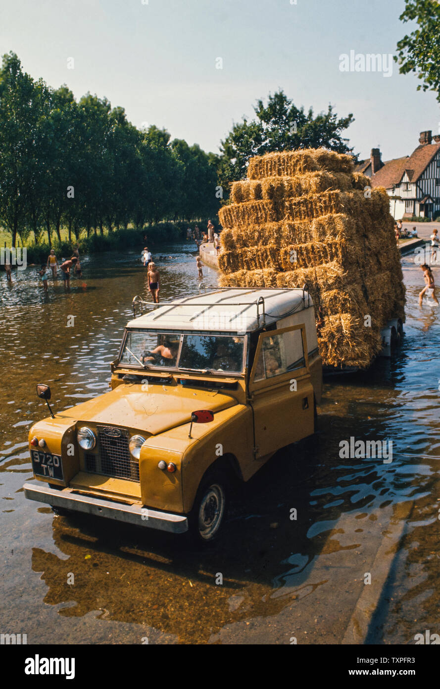 Eynsford Kent England 1975 A landrover carries bales of straw through ...