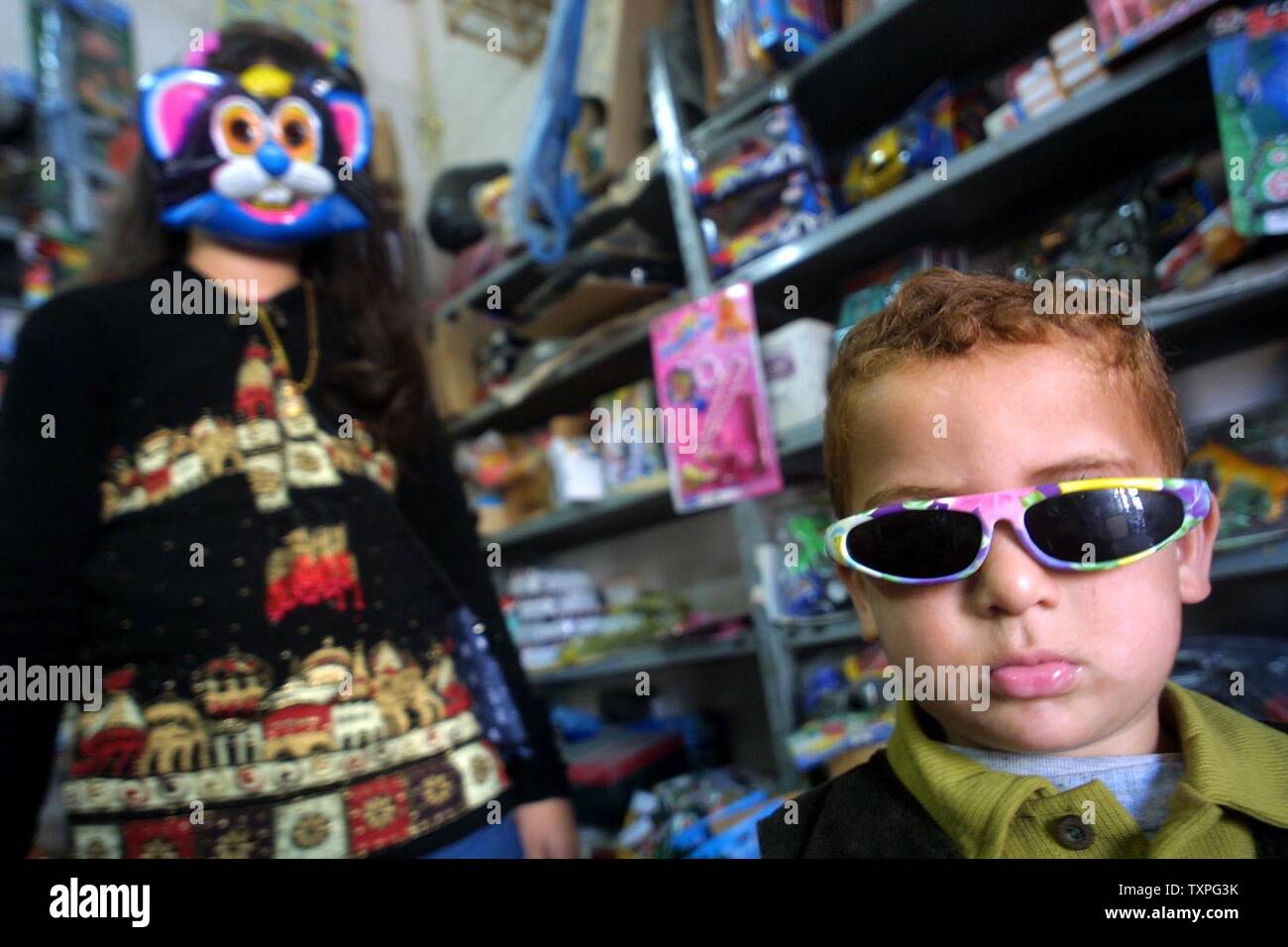 Palestinian children try on costumes at a local store to celebrate Eid ...
