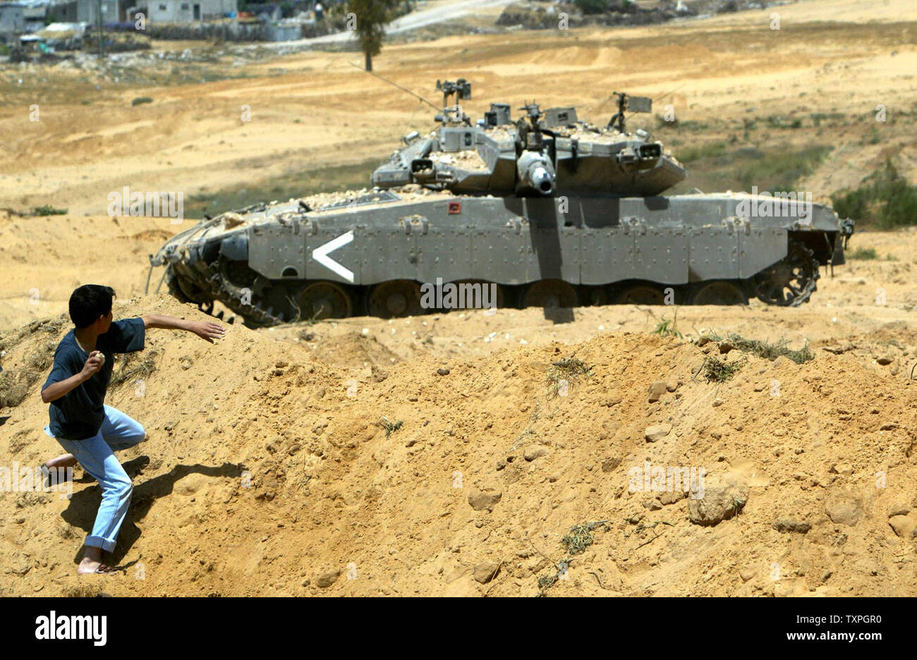 Palestinian Boy Throwing Rock At Tank