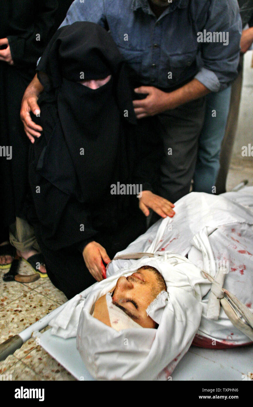 Relatives of Raft Al-Hams,27, grieve as mourners arrived with his body ...