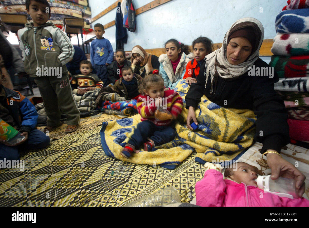Homeless Palestinians set up housekeeping inside a UN school after the ...