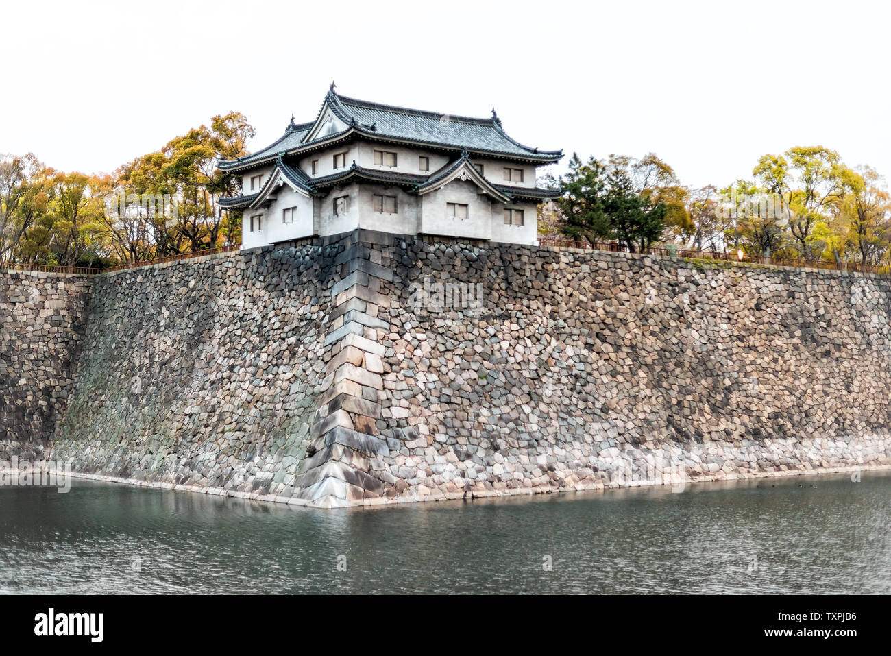 Osaka, Japan pool moat during spring day with royal castle and stone ...